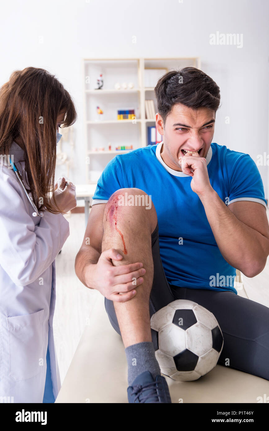 Football soccer player visiting doctor after injury Stock Photo - Alamy