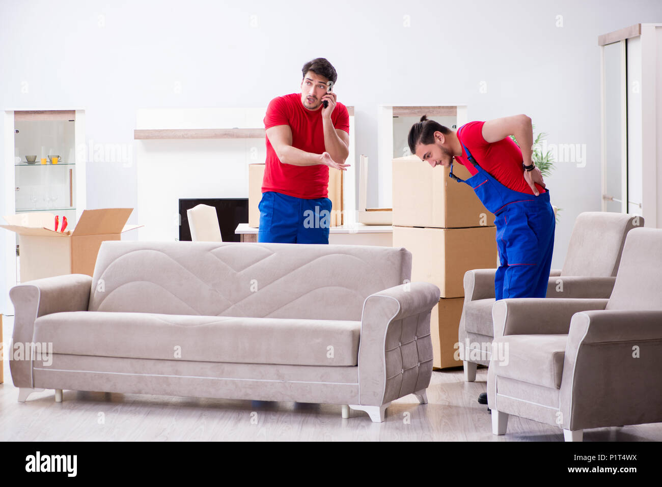 Two contractor employees moving personal belongings Stock Photo - Alamy