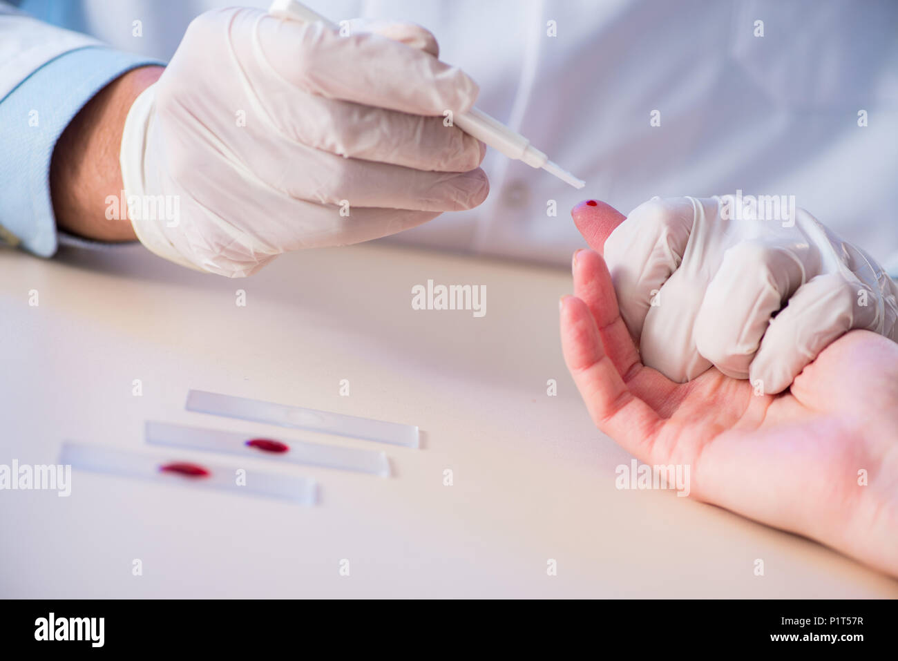 Doctor taking blood samples from finger Stock Photo - Alamy