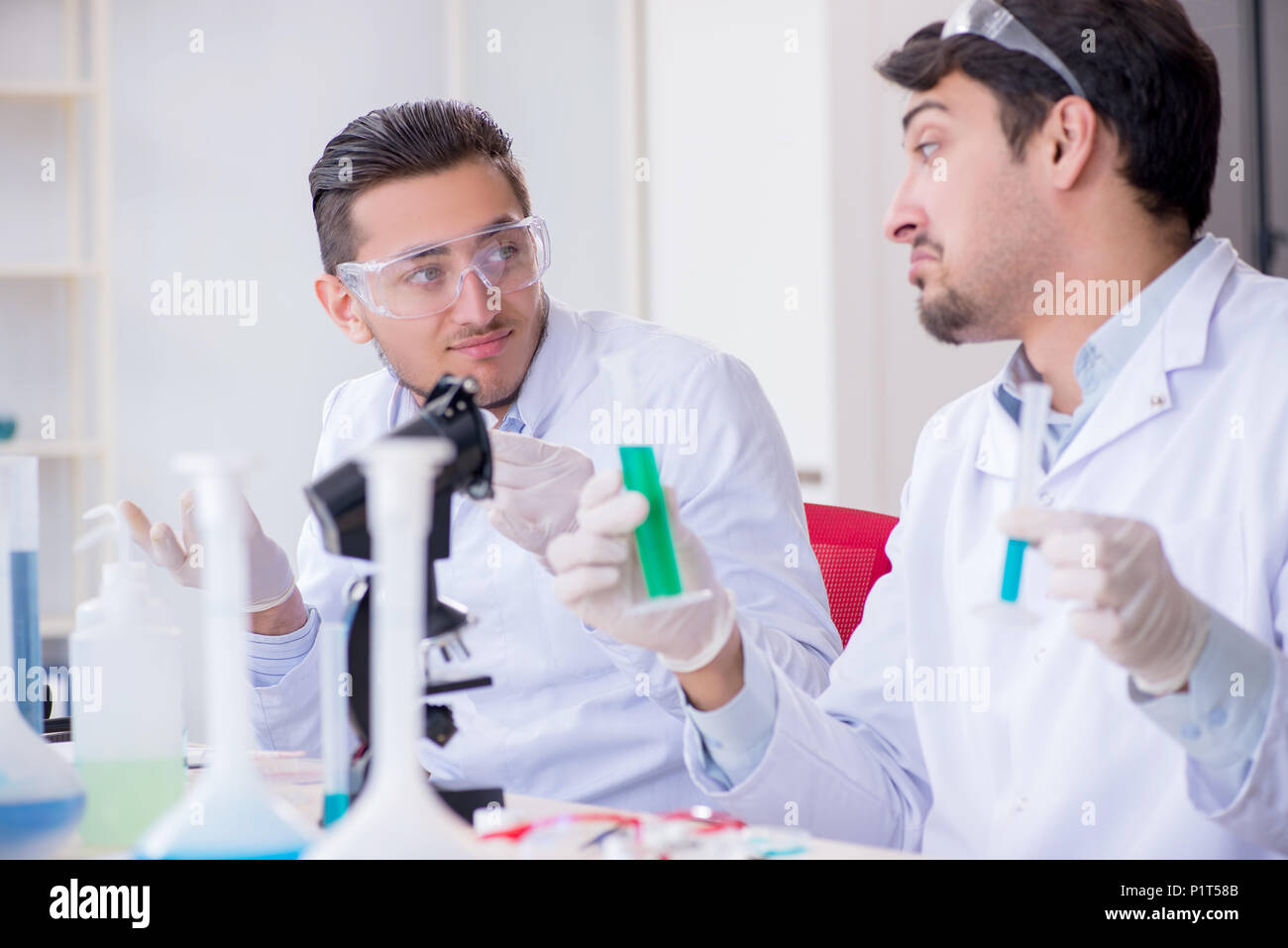 Team of chemists working in the lab Stock Photo - Alamy
