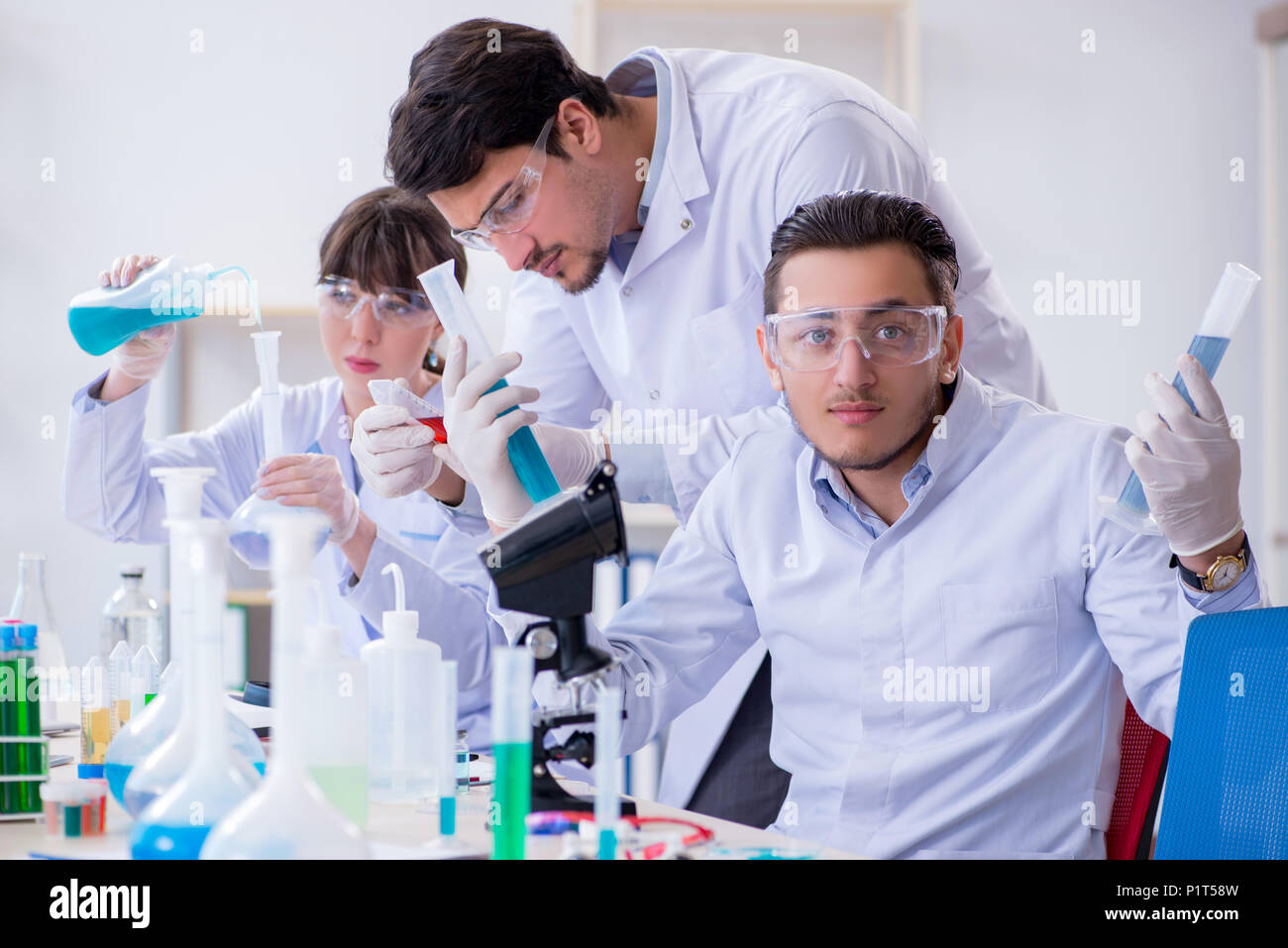 Team of chemists working in the lab Stock Photo - Alamy