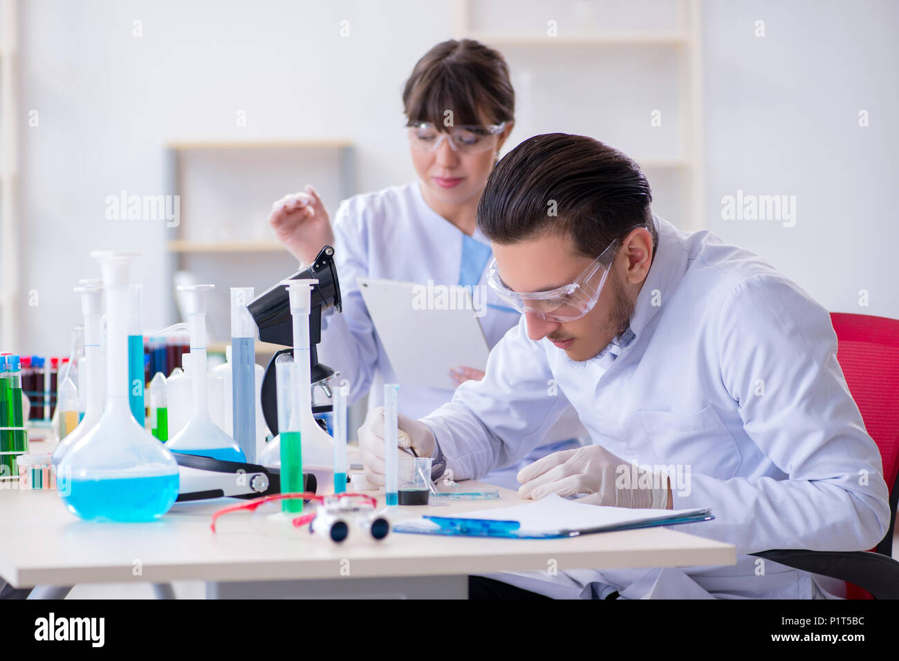 Team of chemists working in the lab Stock Photo - Alamy