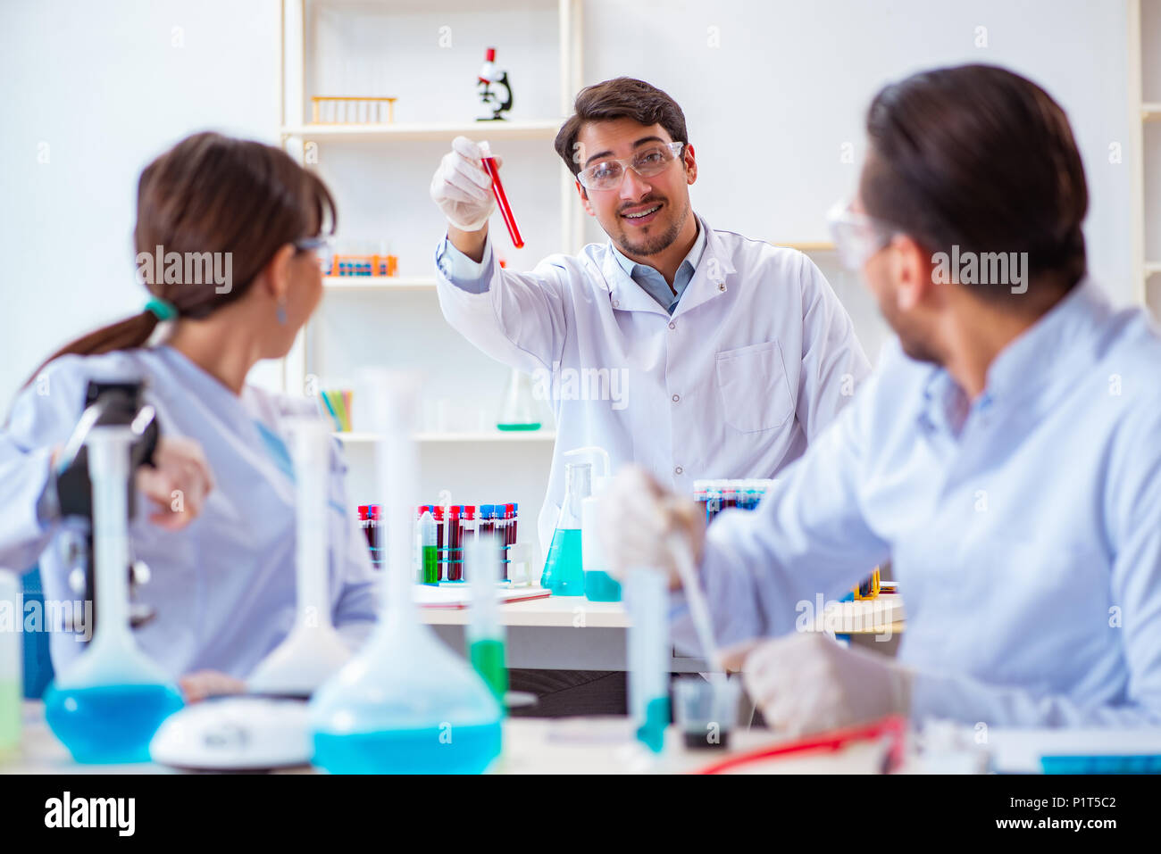 Team of chemists working in the lab Stock Photo - Alamy