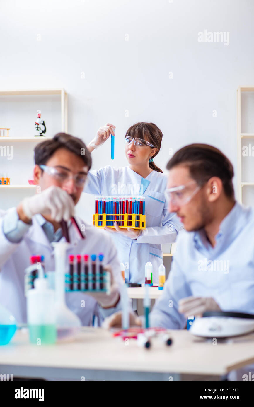 Team of chemists working in the lab Stock Photo - Alamy