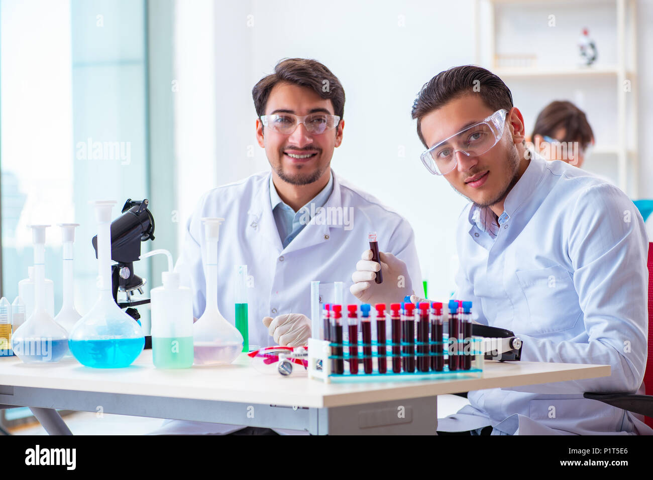 Team of chemists working in the lab Stock Photo - Alamy