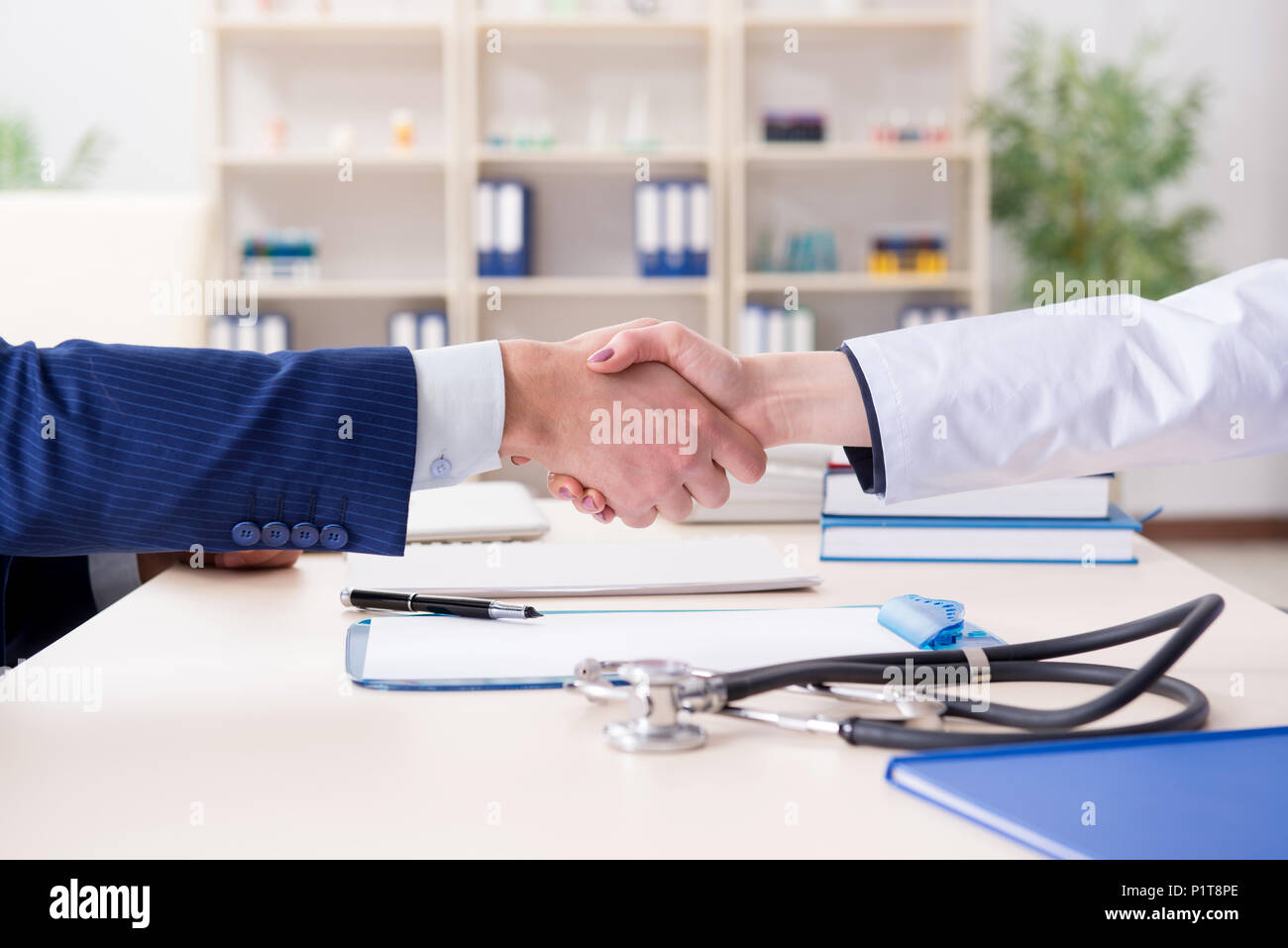 Man signing medical insurance contract Stock Photo - Alamy