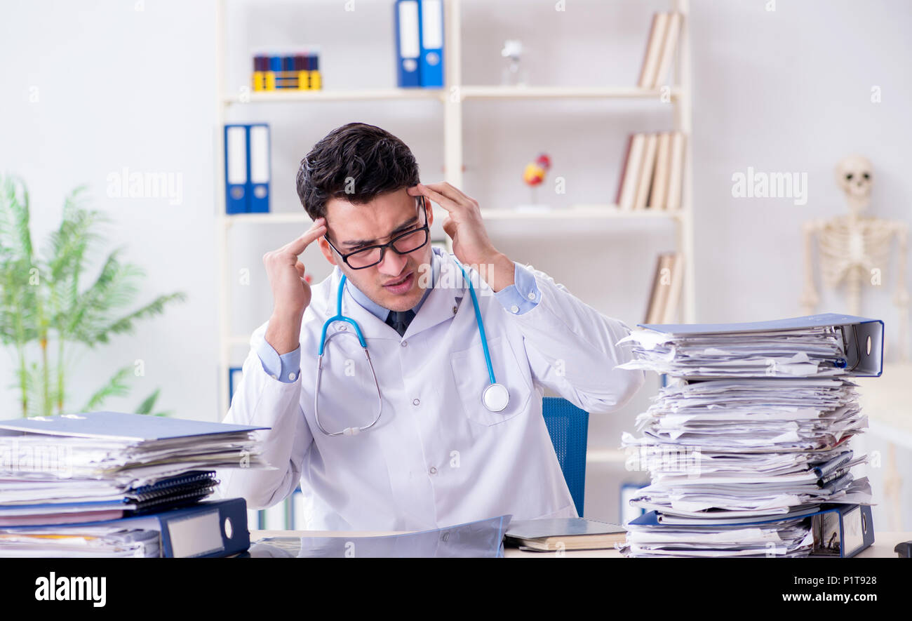 Busy doctor with too much work in hospital Stock Photo - Alamy