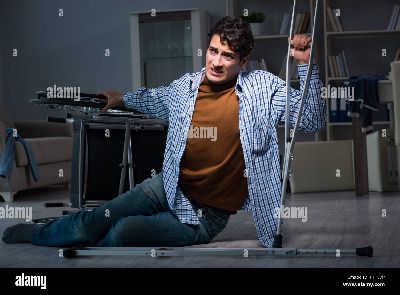 Man fell off wheelchair sitting on the floor Stock Photo - Alamy