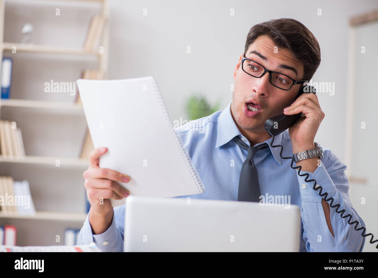 Extremely busy businessman working in office Stock Photo - Alamy