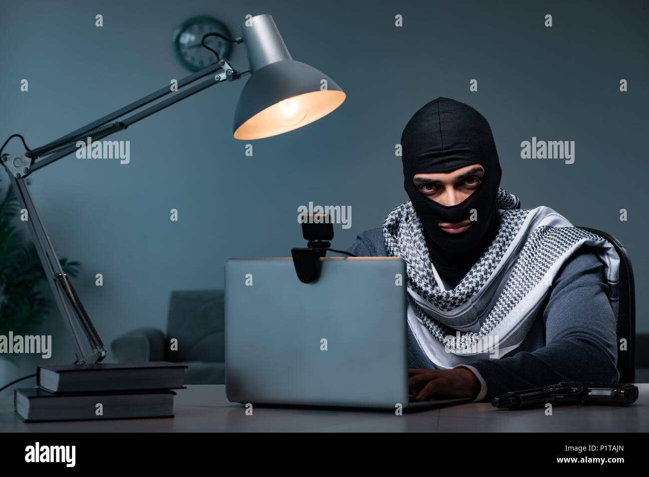 Hacker wearing balaclava mask hacking computer Stock Photo - Alamy
