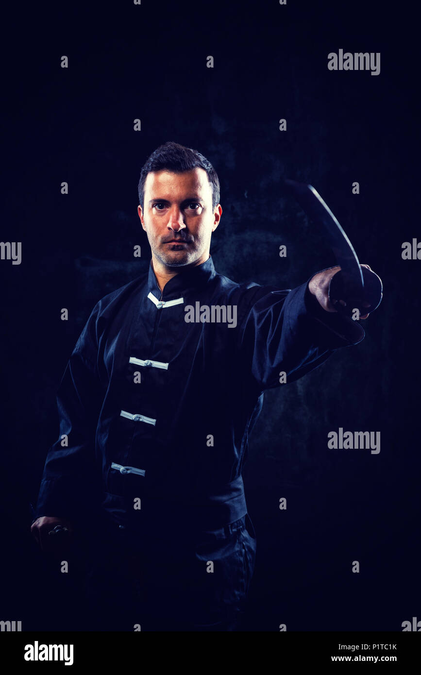Man exercise Tai Chi over black background Stock Photo - Alamy