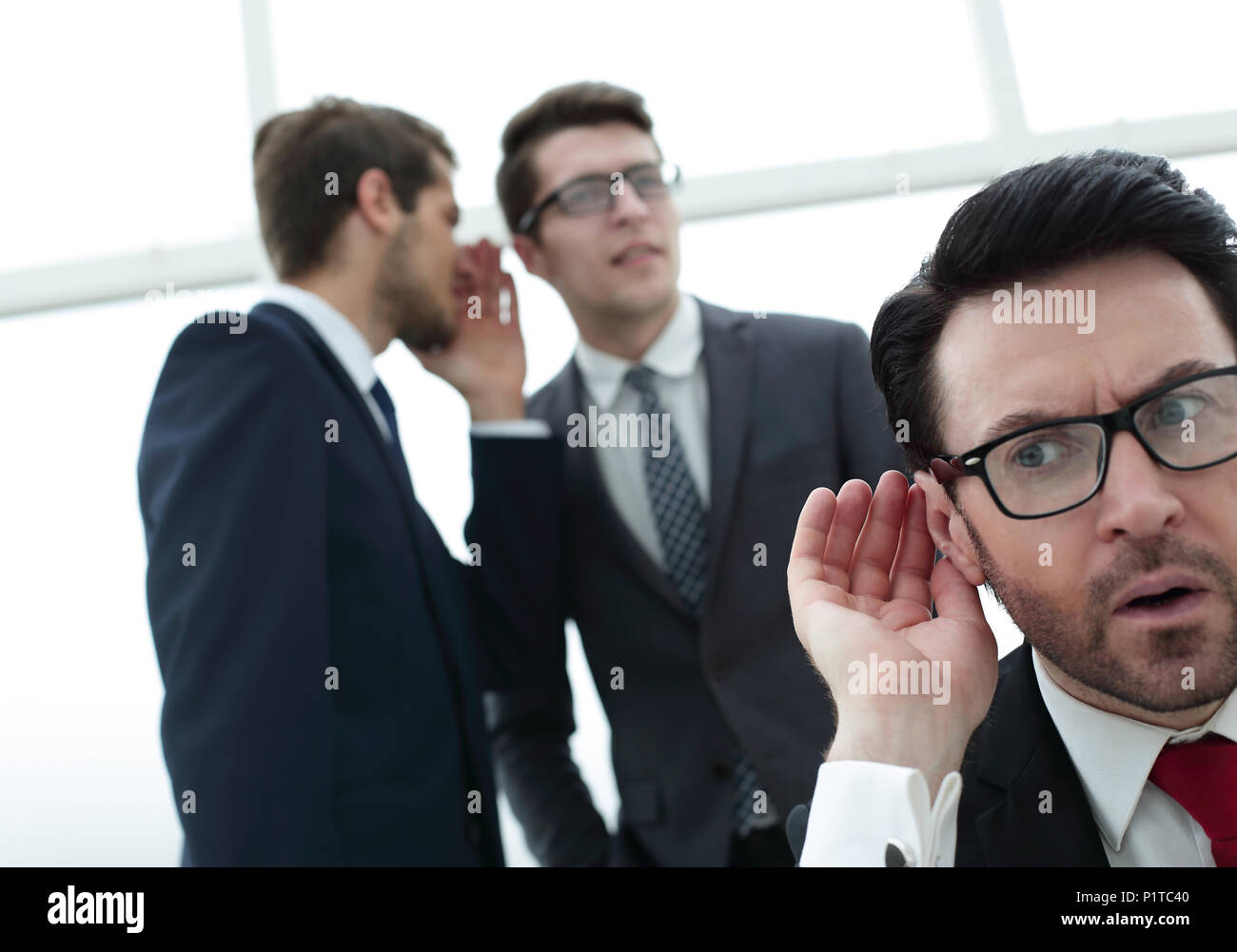 close up.businessman eavesdropping on conversation between colleagues ...