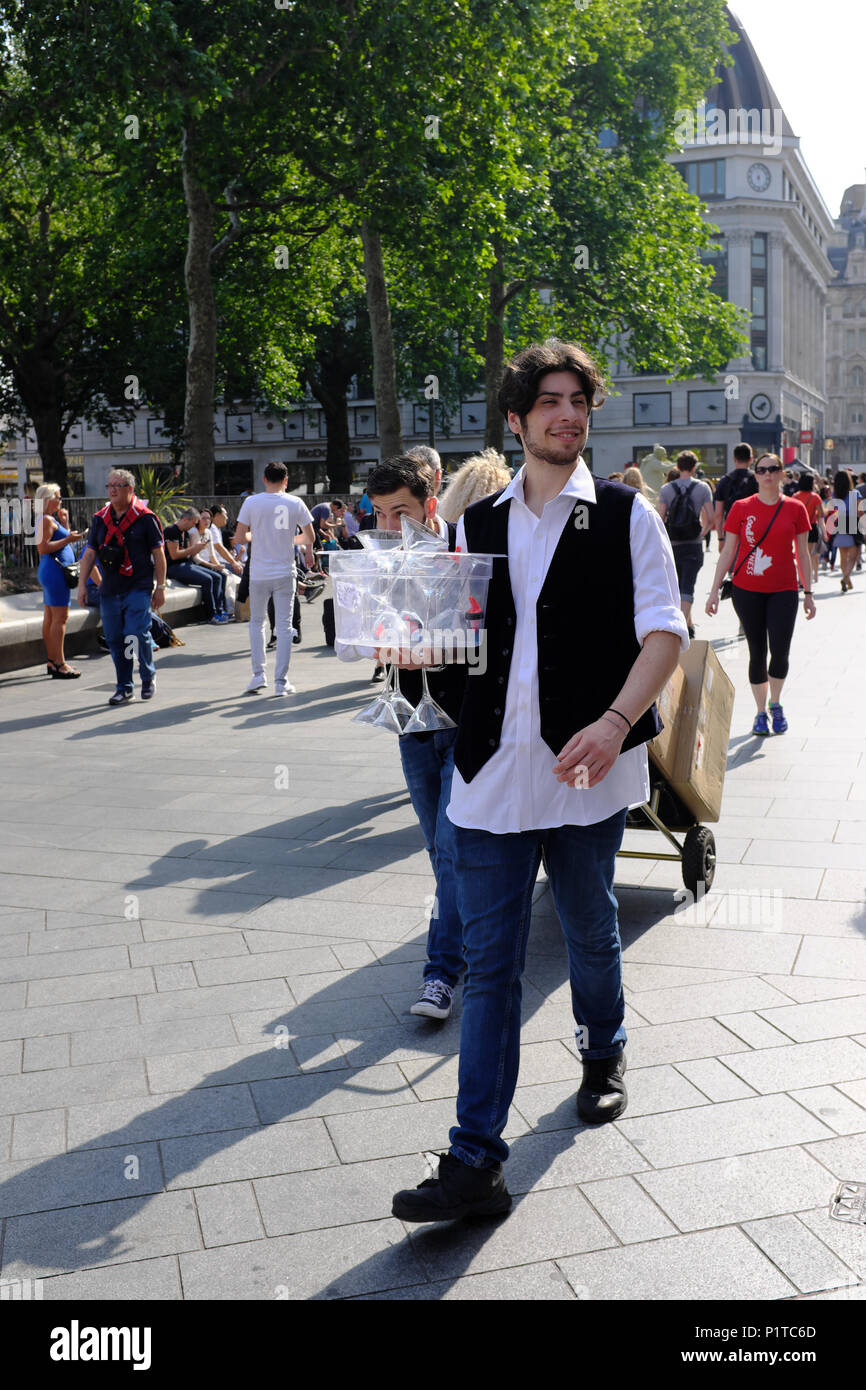 Waiter with glasses on tray in Leicester Square, London, England, UK ...