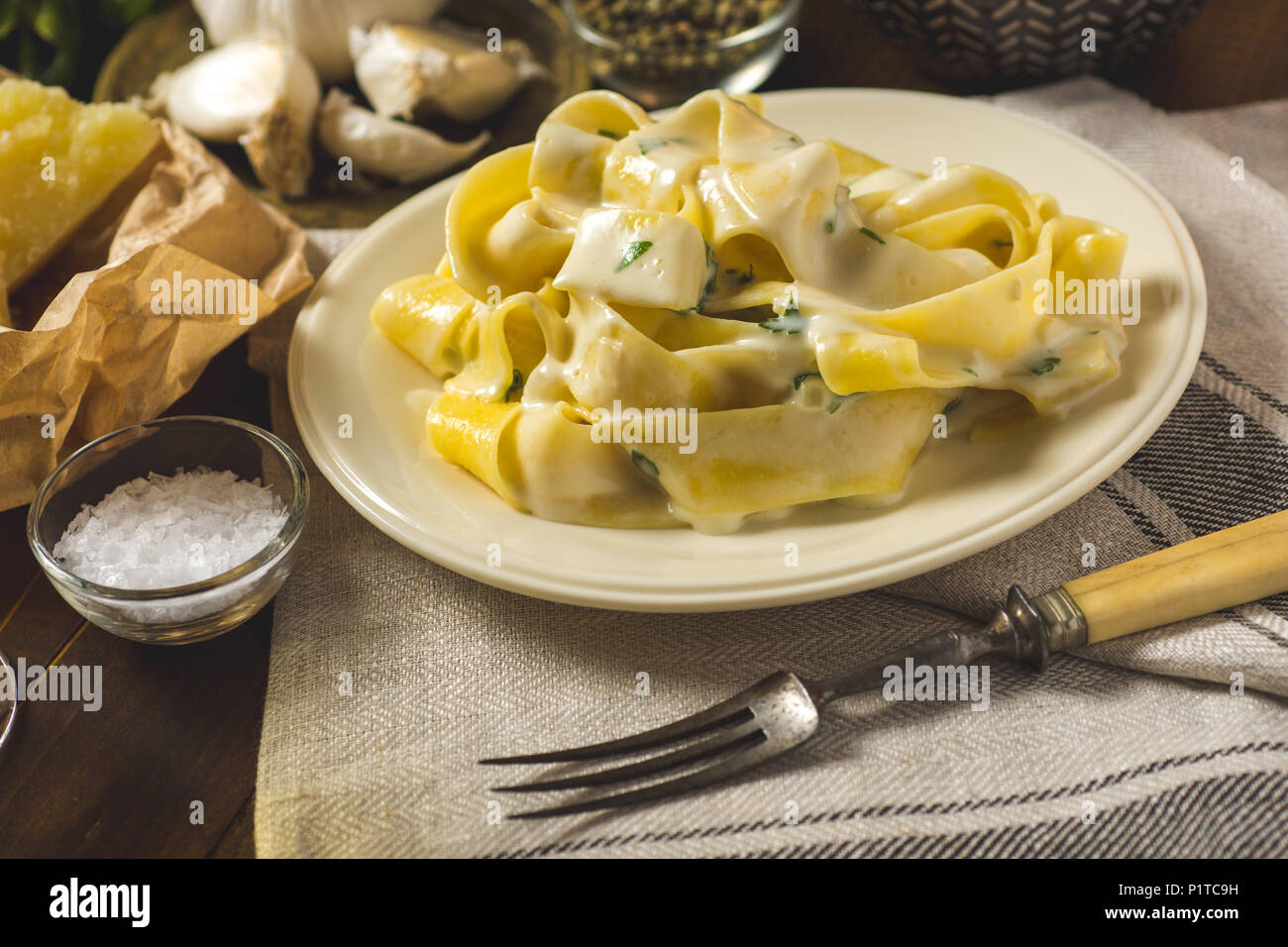 Alfredo Pasta Plate with Creamy Cheese and Basil Sauce Stock Photo - Alamy