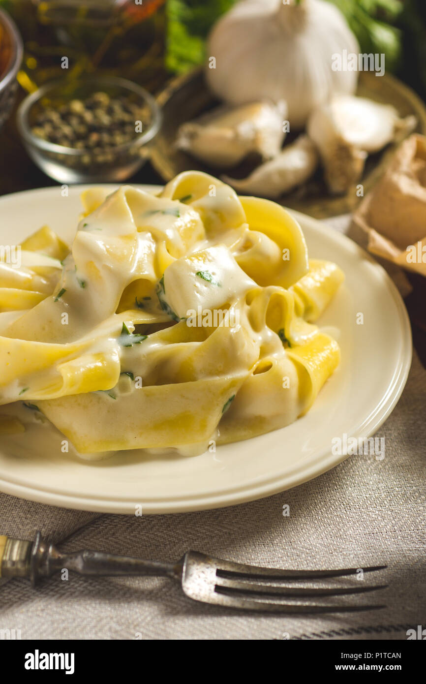 Alfredo Pasta Plate with Creamy Cheese and Basil Sauce Stock Photo - Alamy