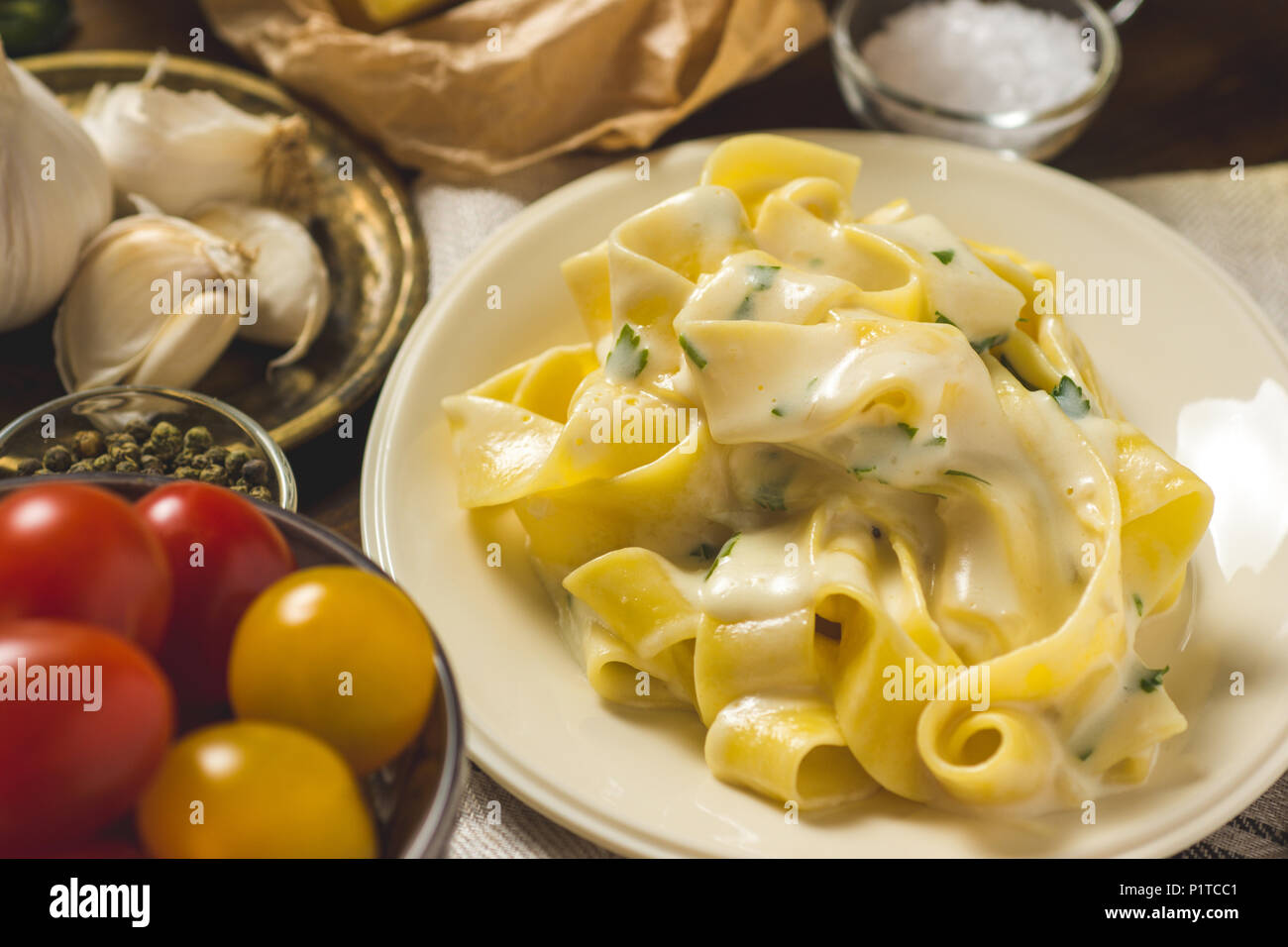 Alfredo Pasta Plate with Creamy Cheese and Basil Sauce Stock Photo - Alamy