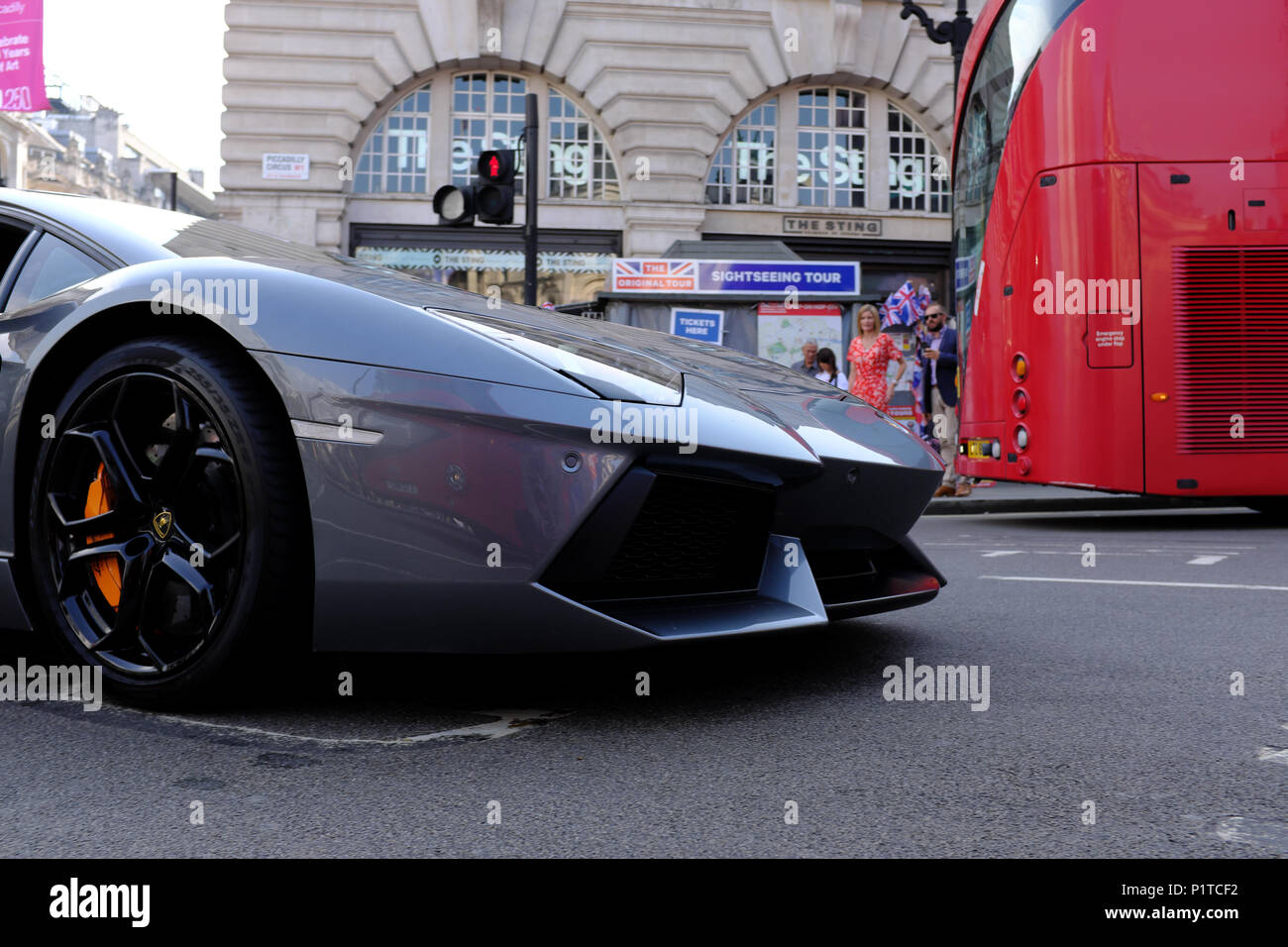 Lamborghini driving through traffic, Piccadilly Circus, London, England ...