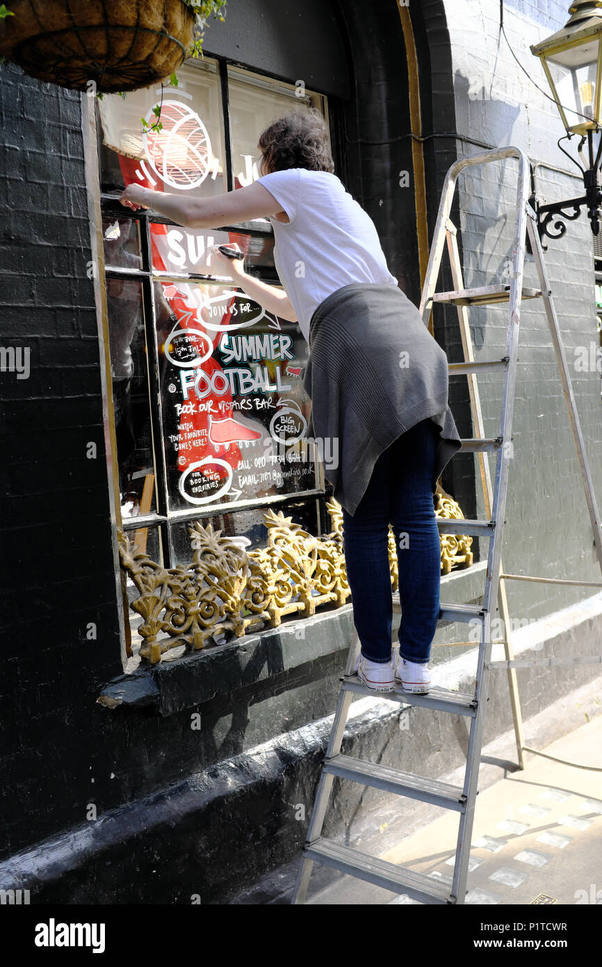 The Glassblower Pub, sign writer on step ladder, Soho, London, England ...