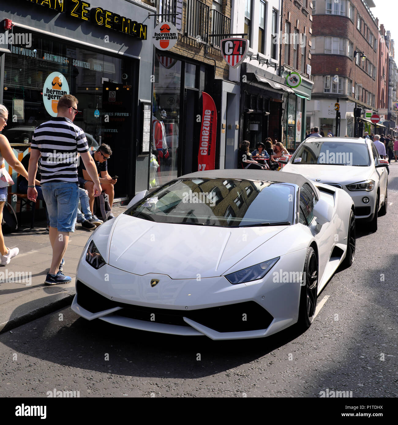 Lamborghini sports car with parking fines on windscreen, Soho, London ...
