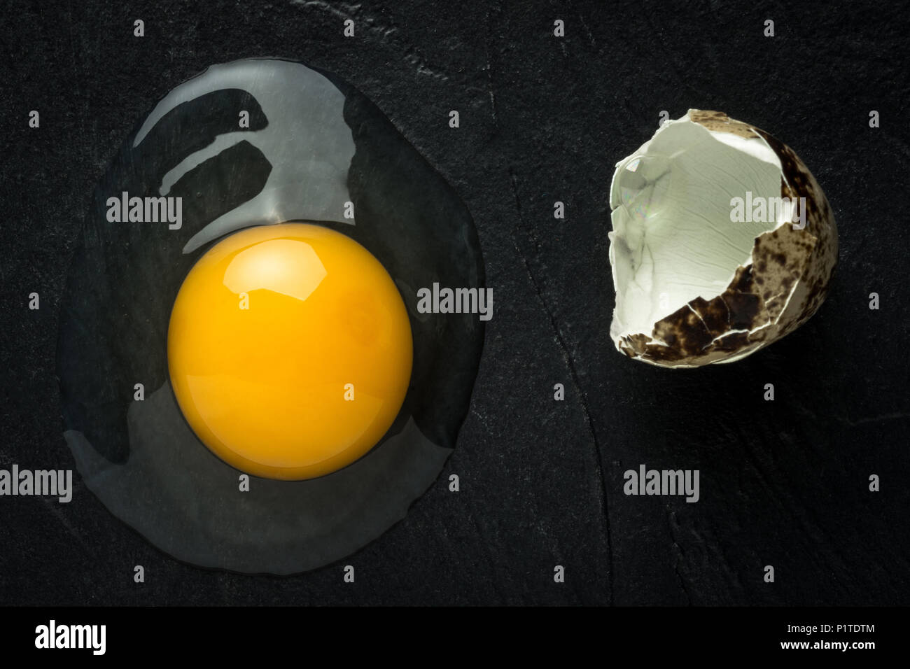 Raw Broken Egg Yolk on Dark Stone Background. Fresh Organic Food ...