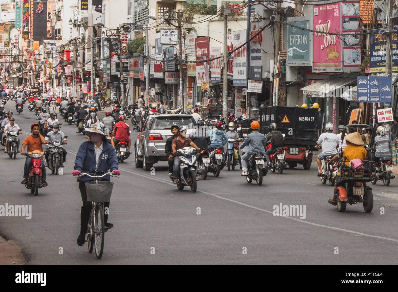 Saigon, Vietnam - January 2014: Scooter traffic on crowded streets with ...