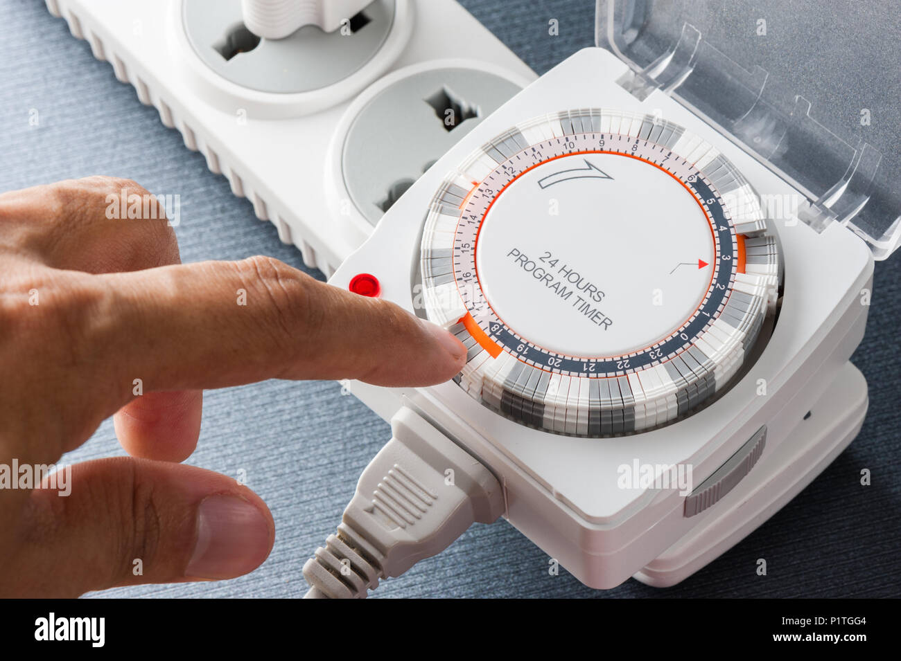 adjusting the electrical socket with 24 hours program timer Stock Photo ...