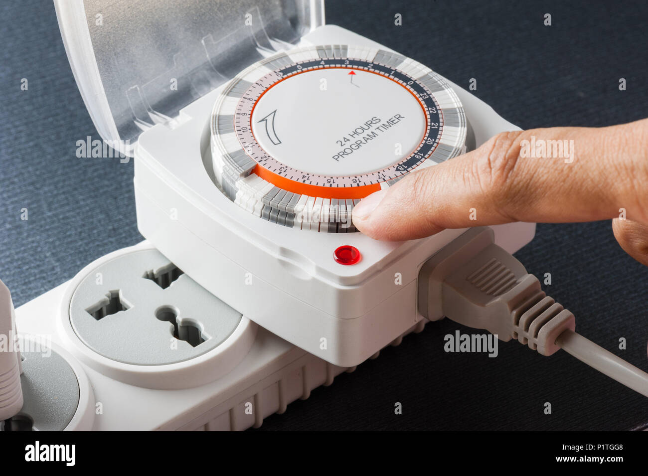 adjusting the electrical socket with 24 hours program timer Stock Photo ...