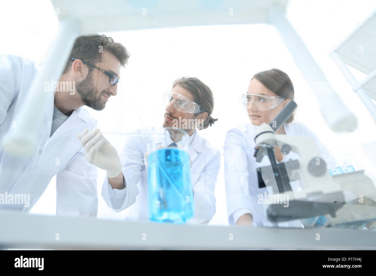 Group of scientists working on an experiment at the laboratory Stock ...