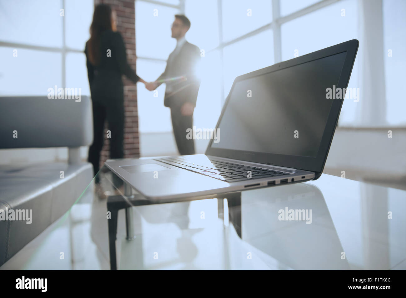 laptop on the desk, background handshake Stock Photo - Alamy