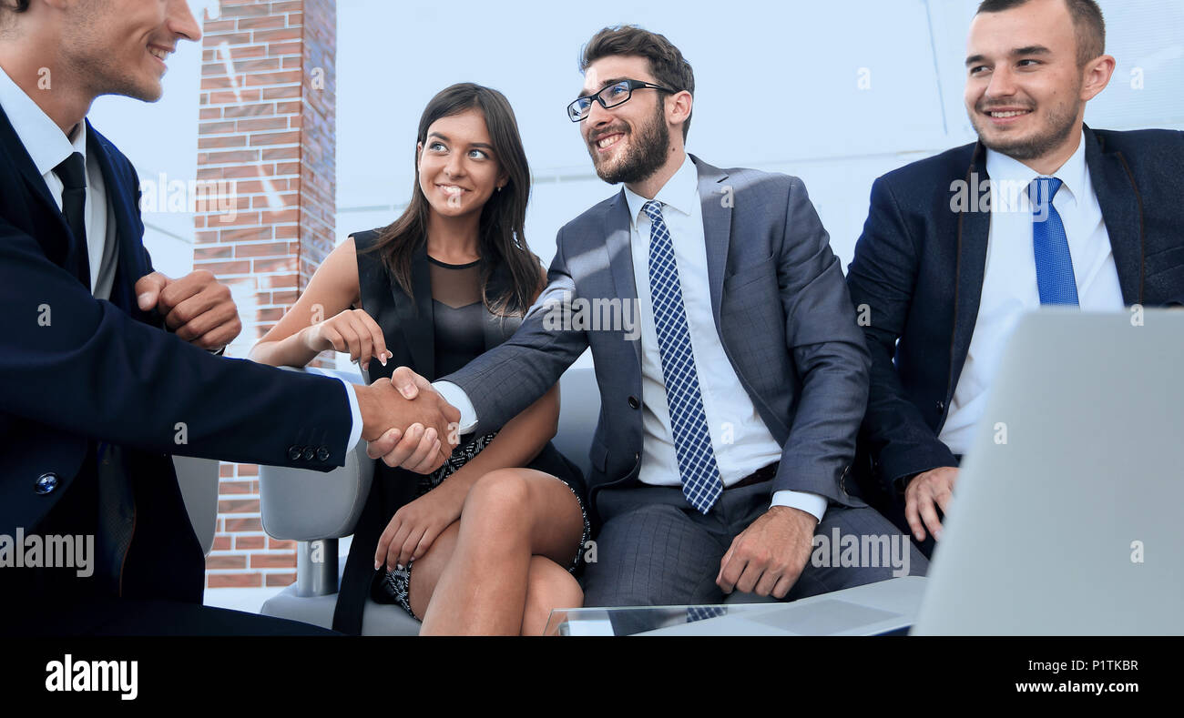 handshake Manager and the client at a meeting in the office lobby Stock ...