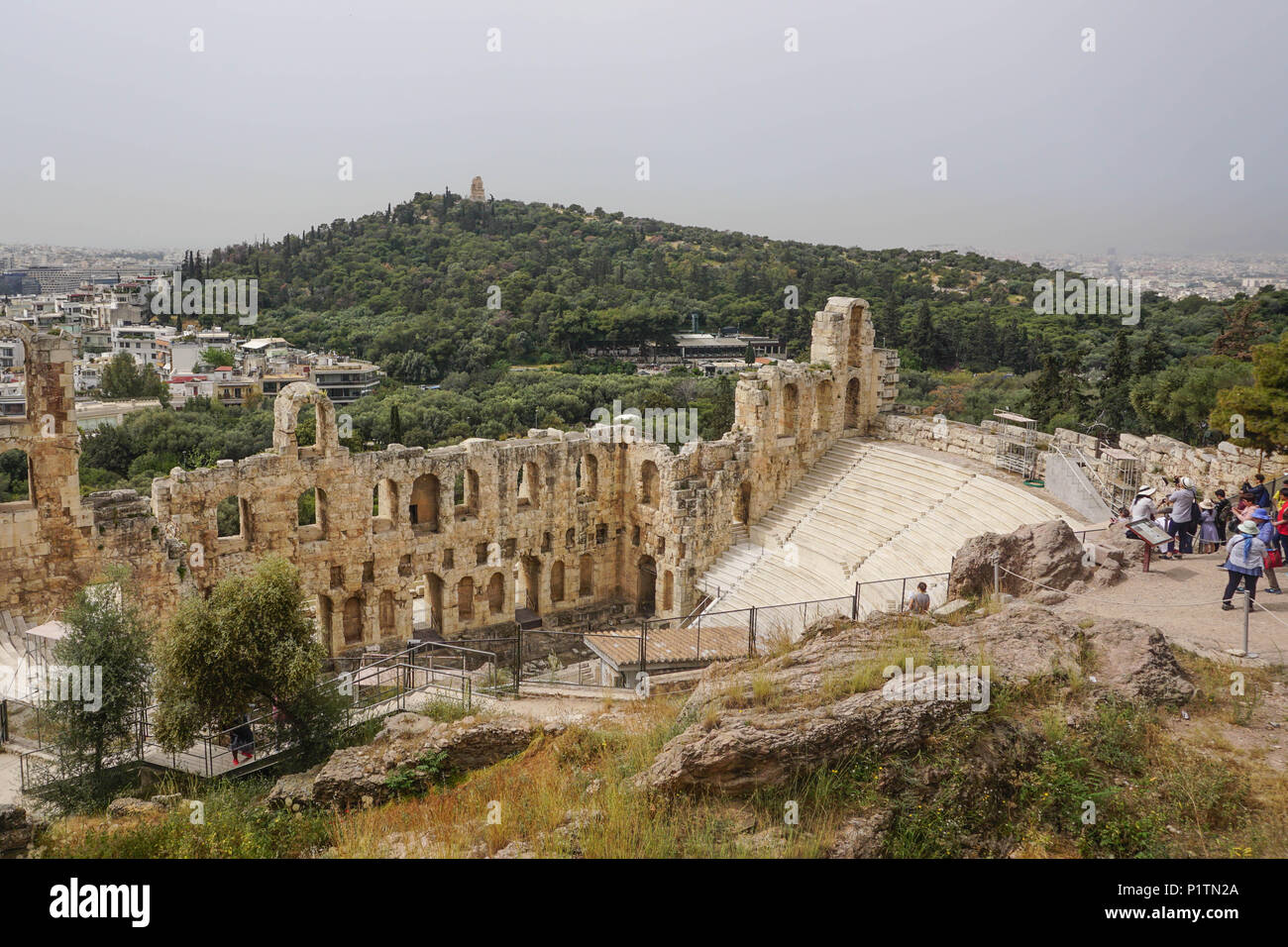 Athens, Greece - April 16, 2018: Tourists view the Odeum of Herodes ...
