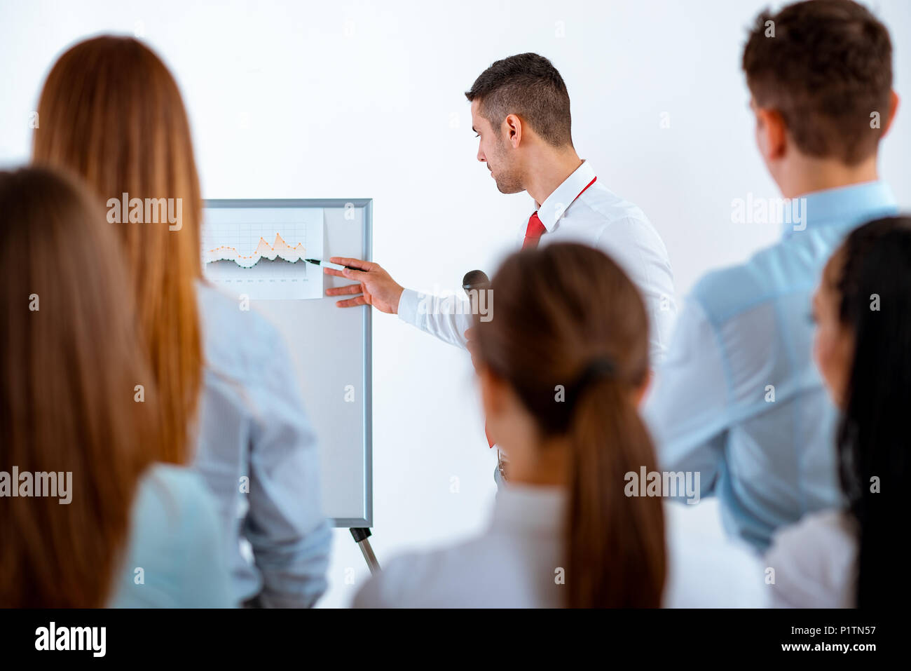 Businesspeople having meeting in a office. Young businessman standing ...