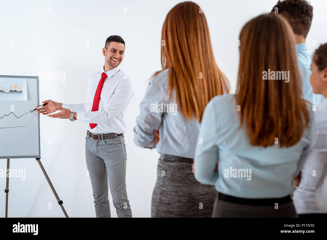 Businesspeople having meeting in a office. Young businessman standing ...