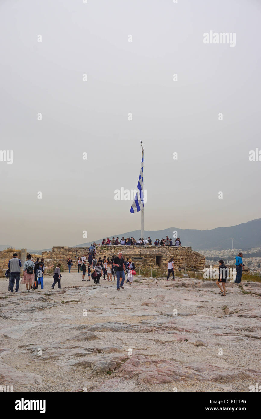 Athens, Greece - April 16, 2018: Tourists gather around the Greek flag ...