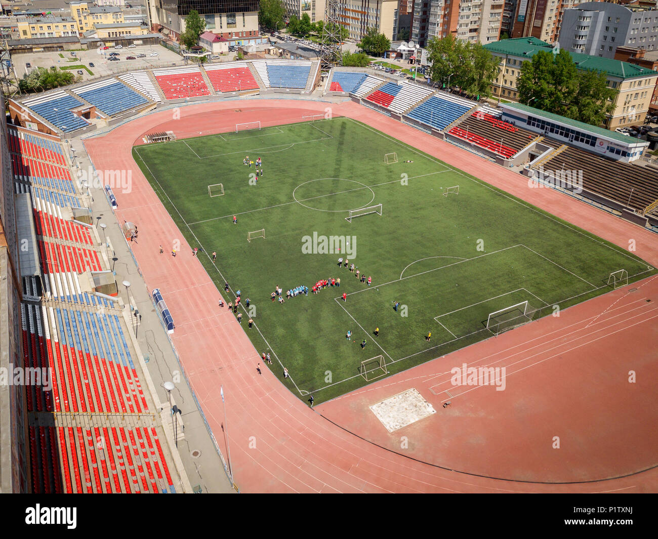 Aerial photography of a modern stadium with green field for football, a ...