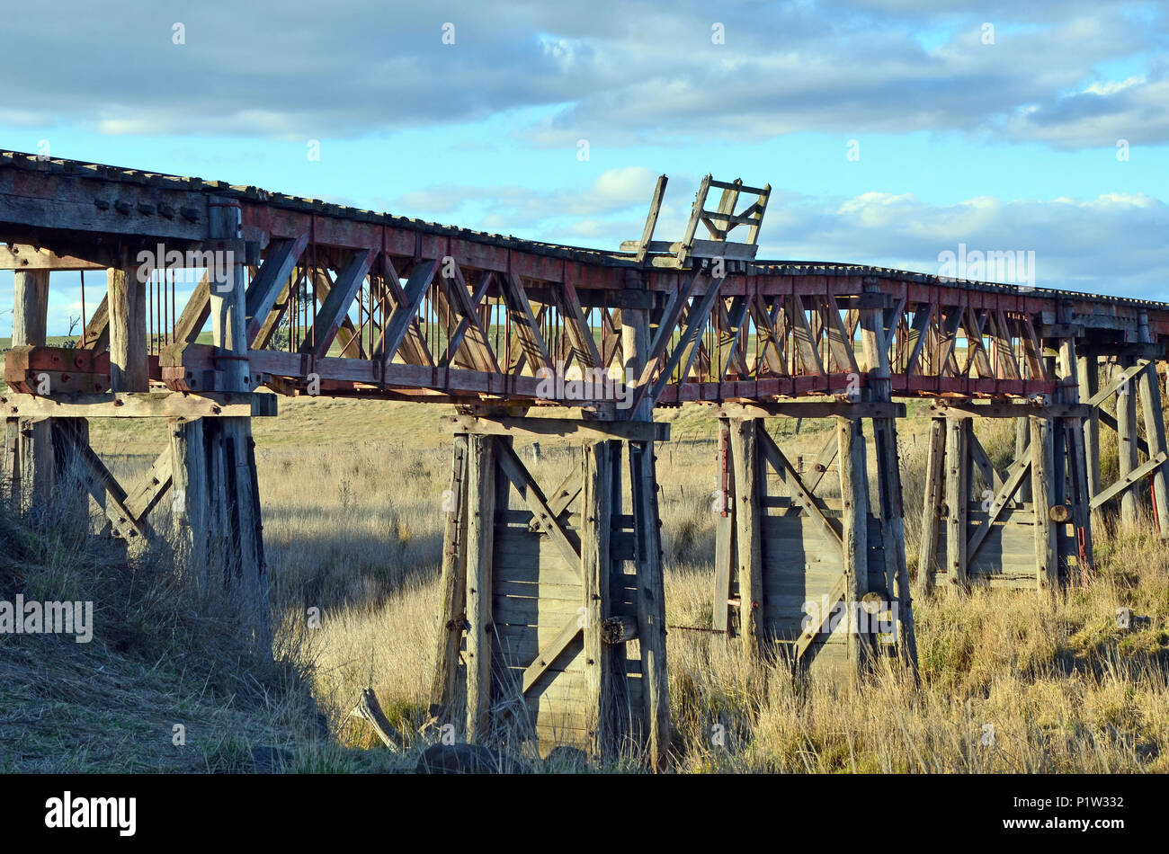 Old abandoned wooden railway bridge over the Boorowa River, in rural ...