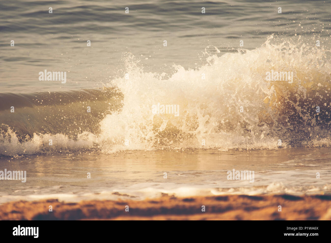 Waves breaking sand beach Stock Photo - Alamy