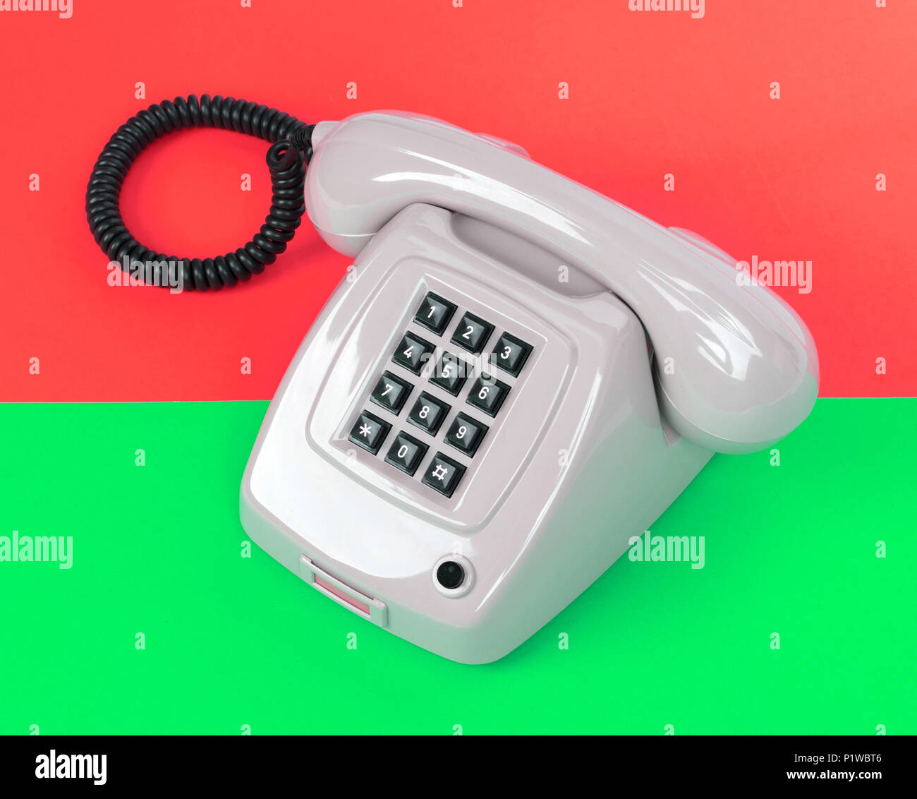 Vintage grey telephone with a colorful background Stock Photo - Alamy