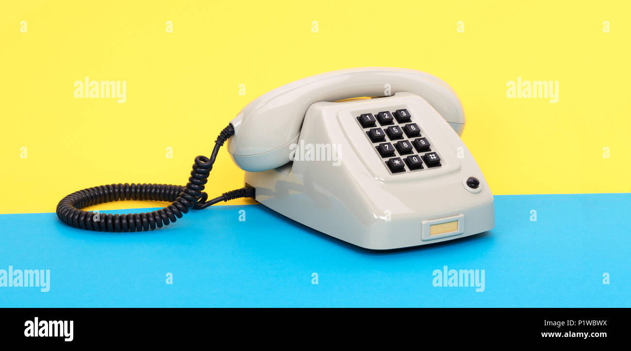 Vintage grey telephone with a colorful background Stock Photo - Alamy