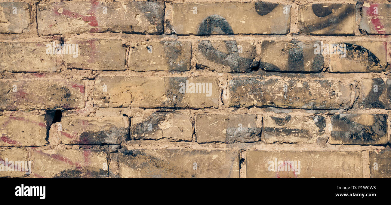 Old brick wall with graffiti fragments Stock Photo - Alamy