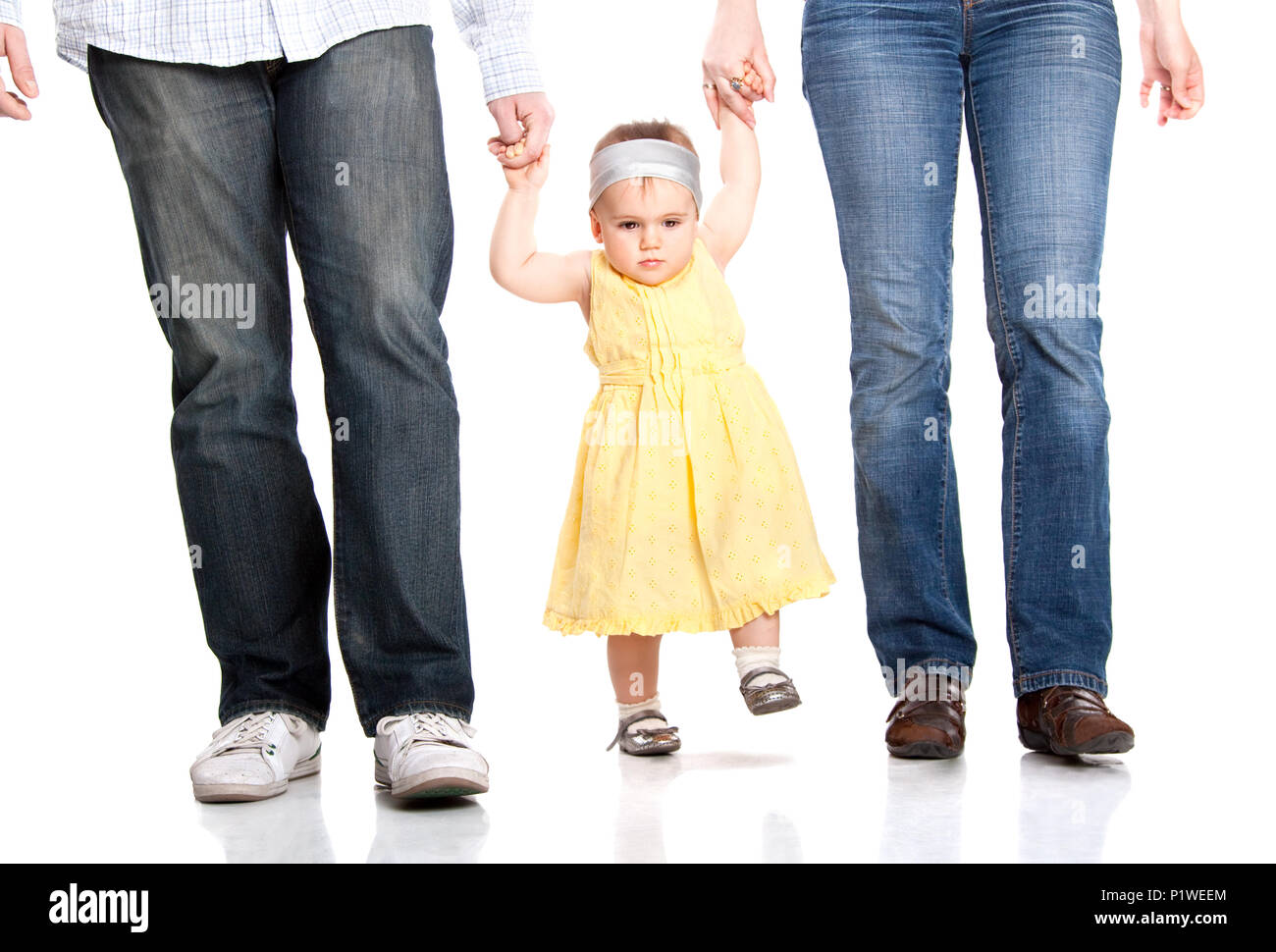 Happy family. Father, mother and baby's first steps Stock Photo - Alamy