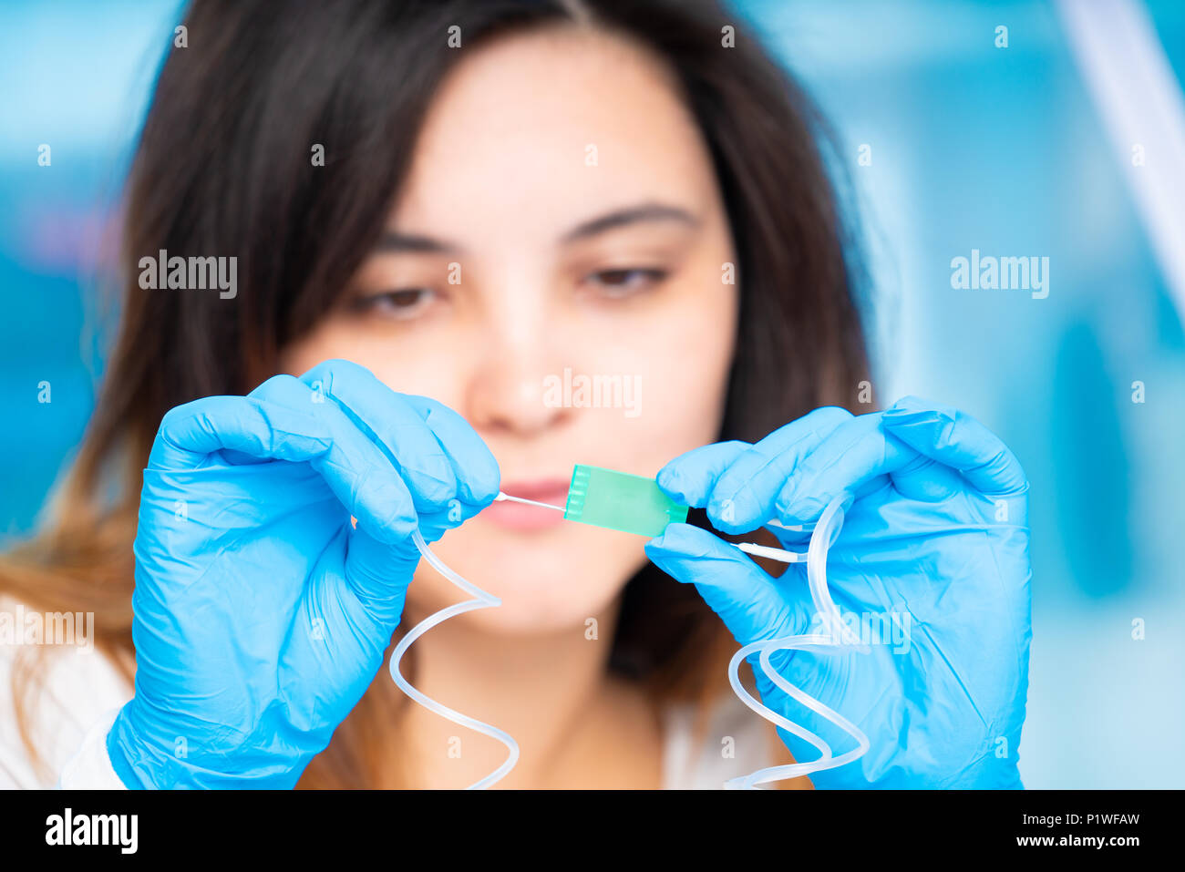 technician girl with microfluidic device LOC in microbiological lab ...
