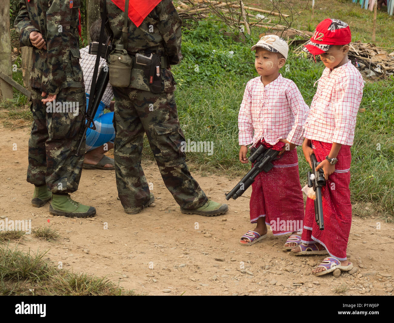 Boys with toy guns next to rebels of the Mon militant group at a ...