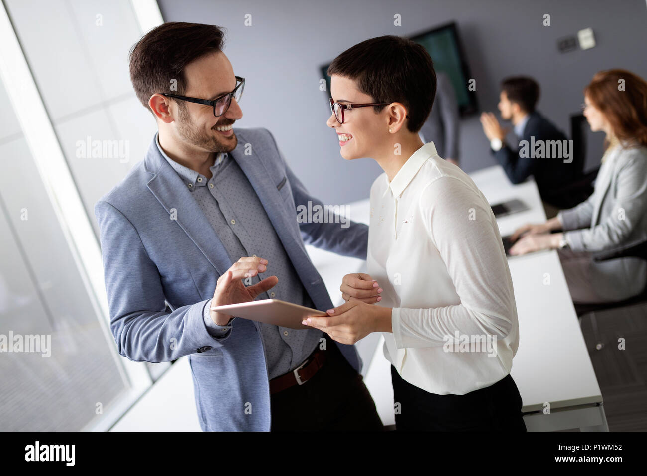 Happy business colleagues in modern office Stock Photo - Alamy