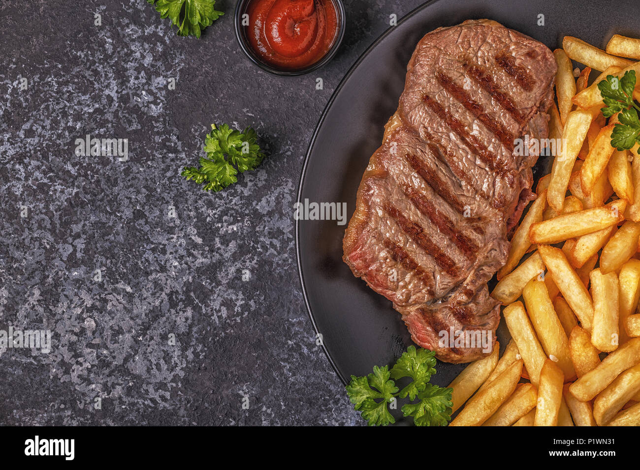 Beef barbecue steak with french fries, top view Stock Photo - Alamy