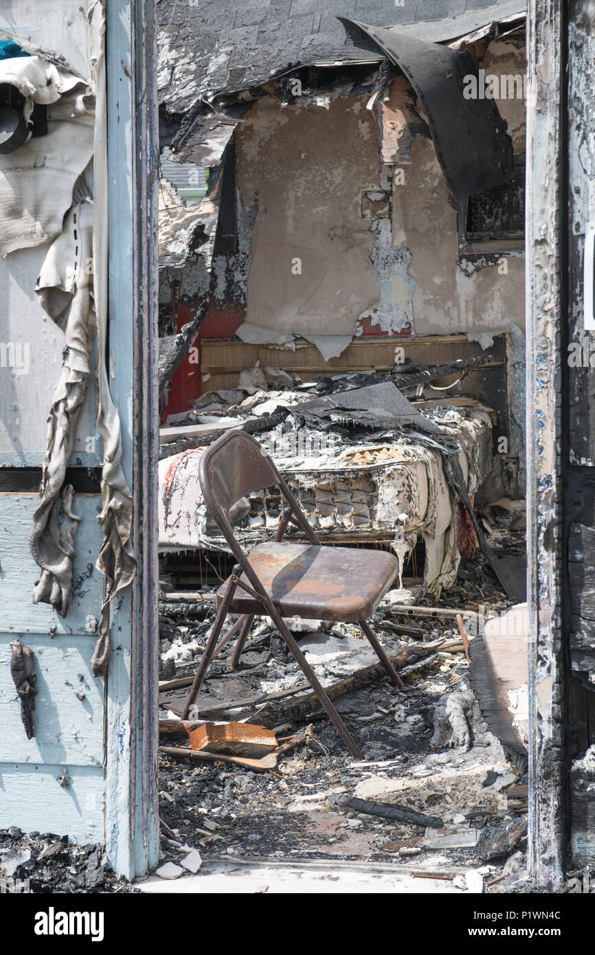 View through the door into a burned out bedroom with a mattress and ...