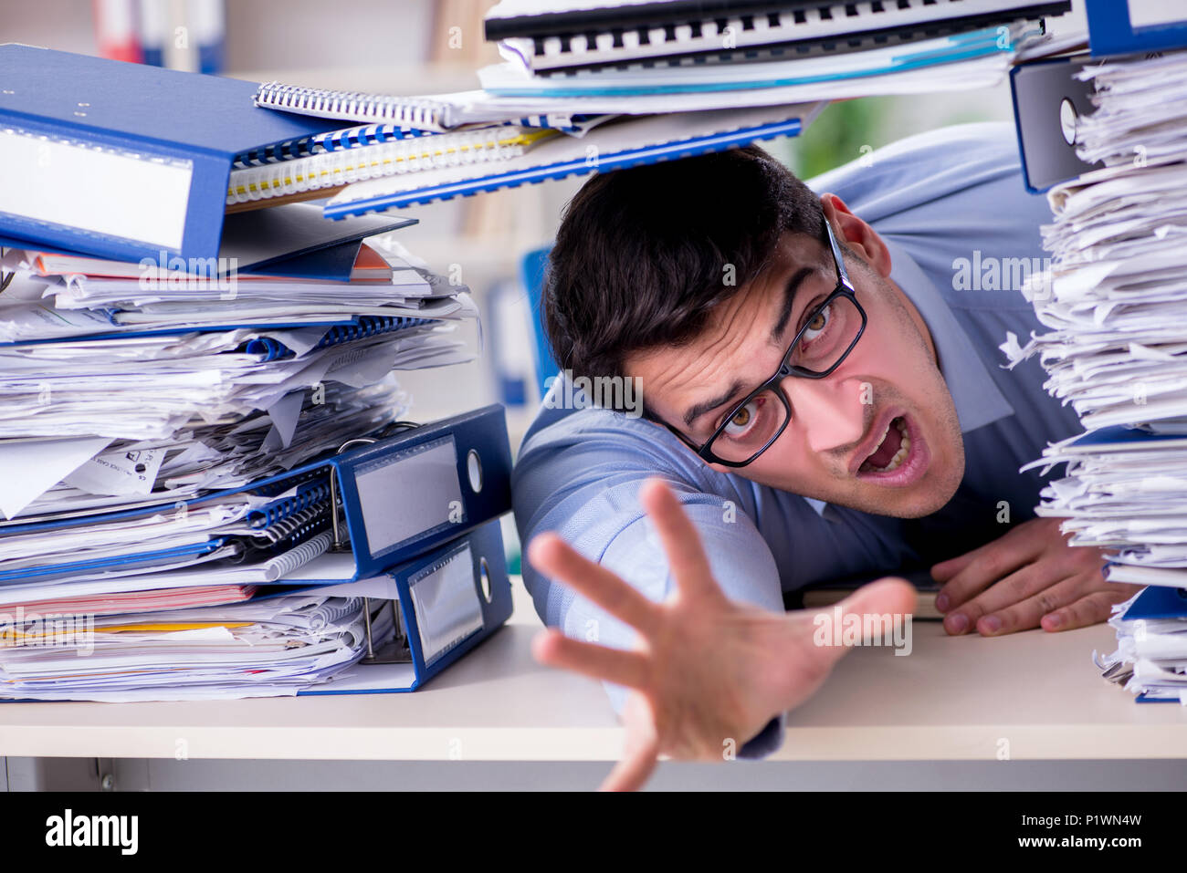 Extremely busy businessman working in office Stock Photo - Alamy