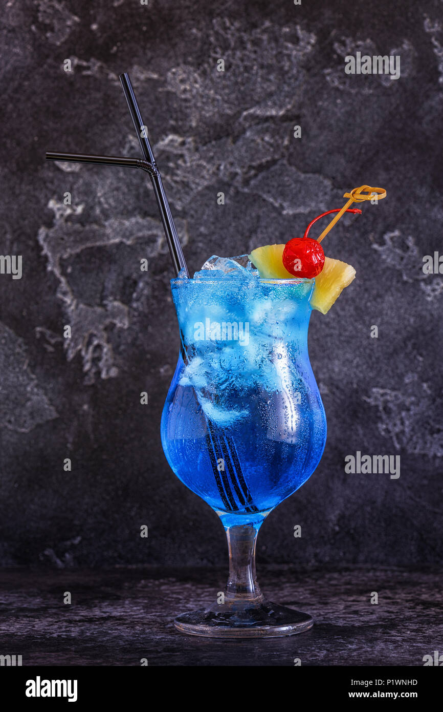 Blue Curacao cocktail decorated with fruit, selective focus Stock Photo ...