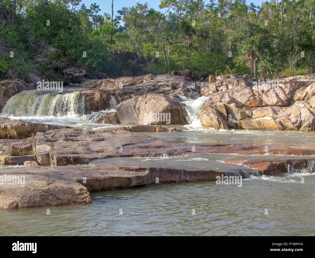 riparian scenery including some rock formations and a small cascade at ...