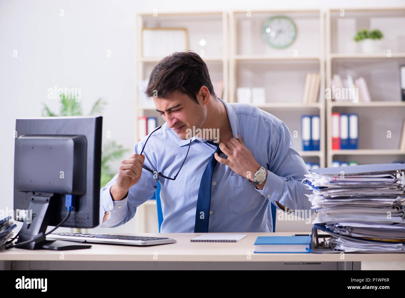 Tired businessman with too much paperwork Stock Photo - Alamy